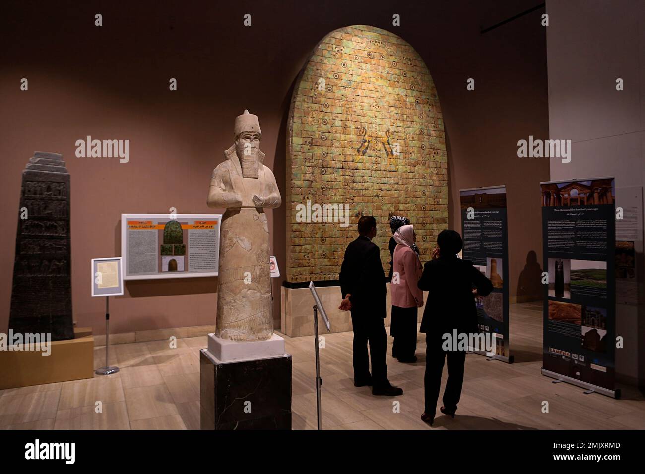 People visit the Assyrian Hall at the Iraq National Museum during ...