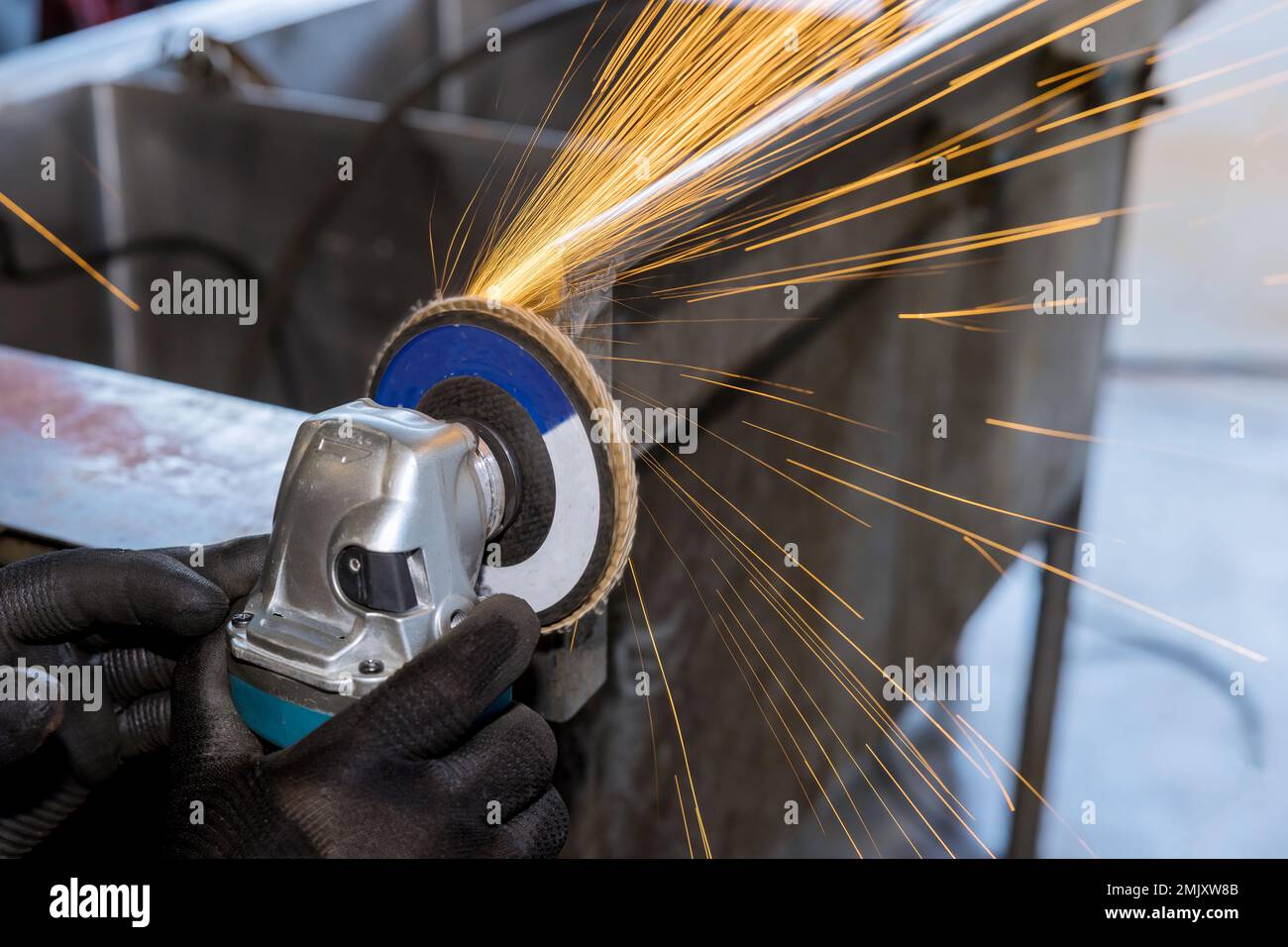 Using grinding iron worker polished metal surfaces Stock Photo - Alamy