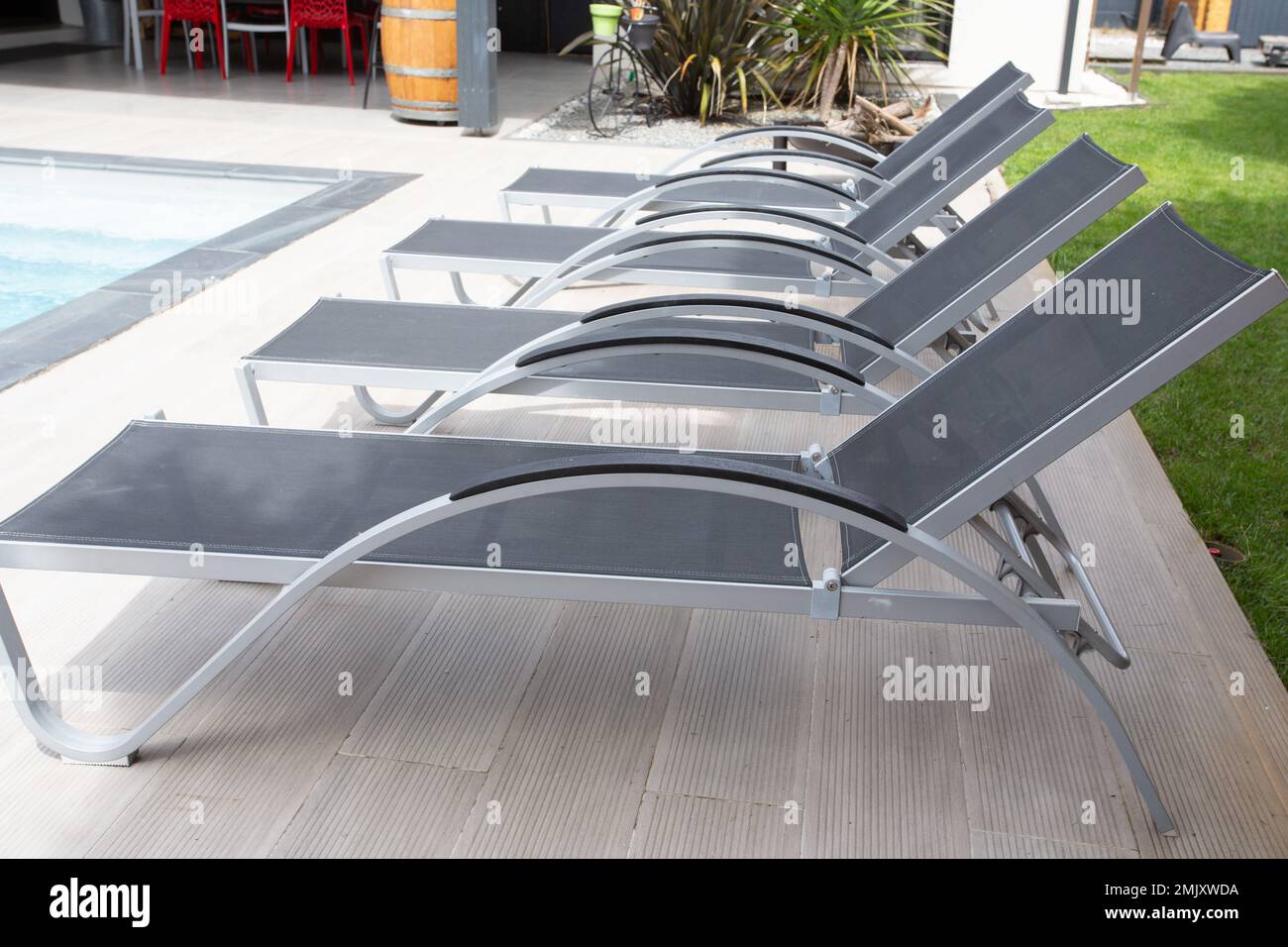 sunbathing lounge chair by private swimming pool Stock Photo - Alamy