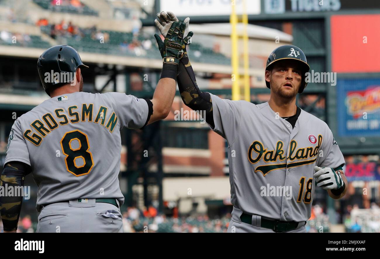 Oakland Athletics' Chad Pinder (18) is greeted at home plate by ...