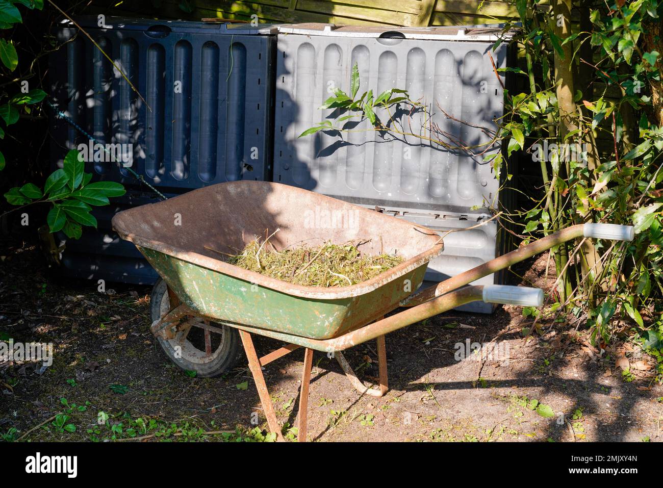 Wheelbarrow with garbage hi-res stock photography and images - Alamy