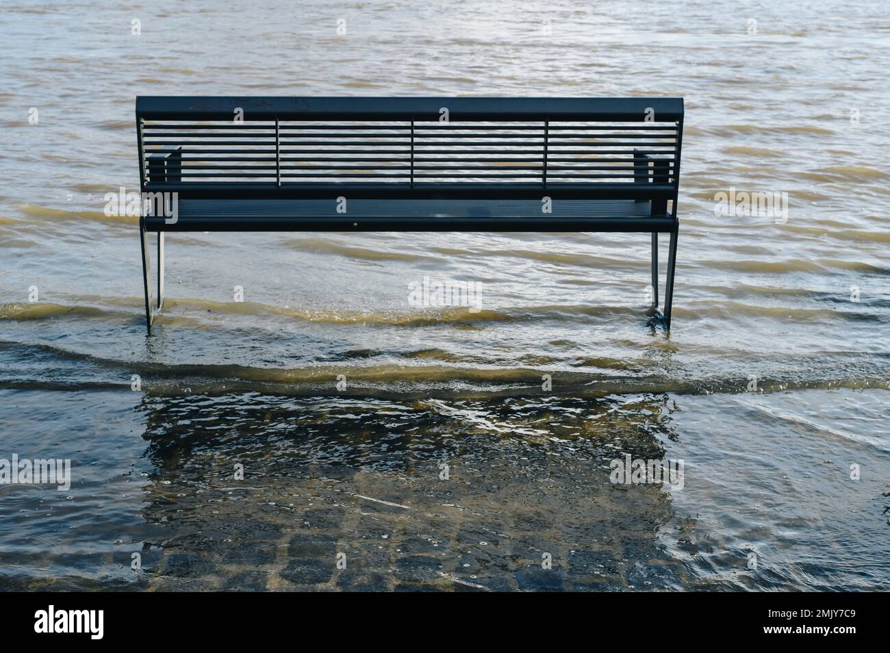 Bench in water. High water after heavy rainfall and snow melting in ...