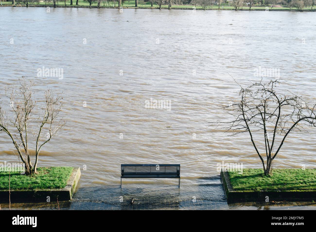 Bench in water. High water after heavy rainfall and snow melting in ...