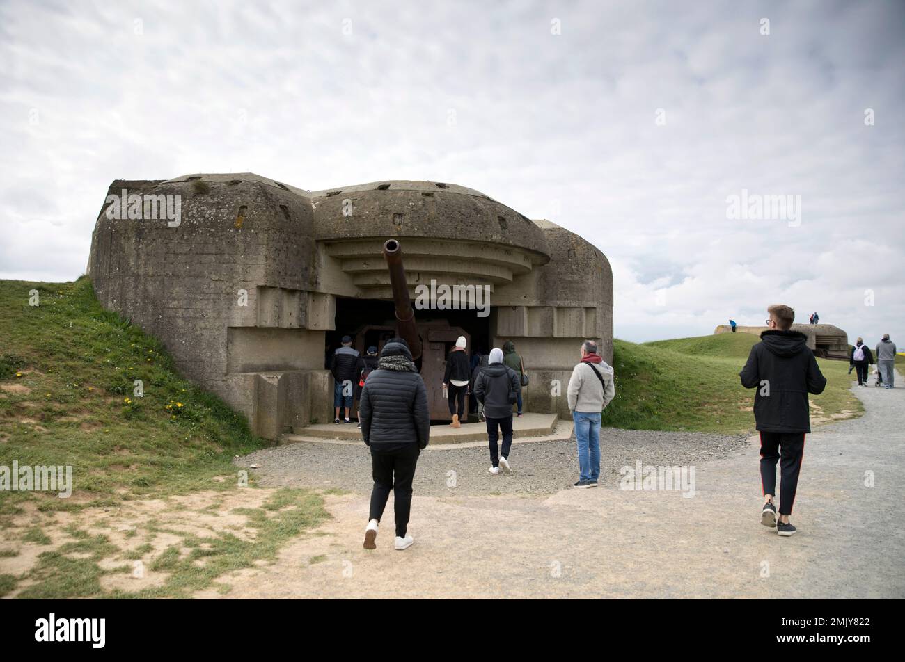 People walk around a German World War II artillery battery in Longues ...
