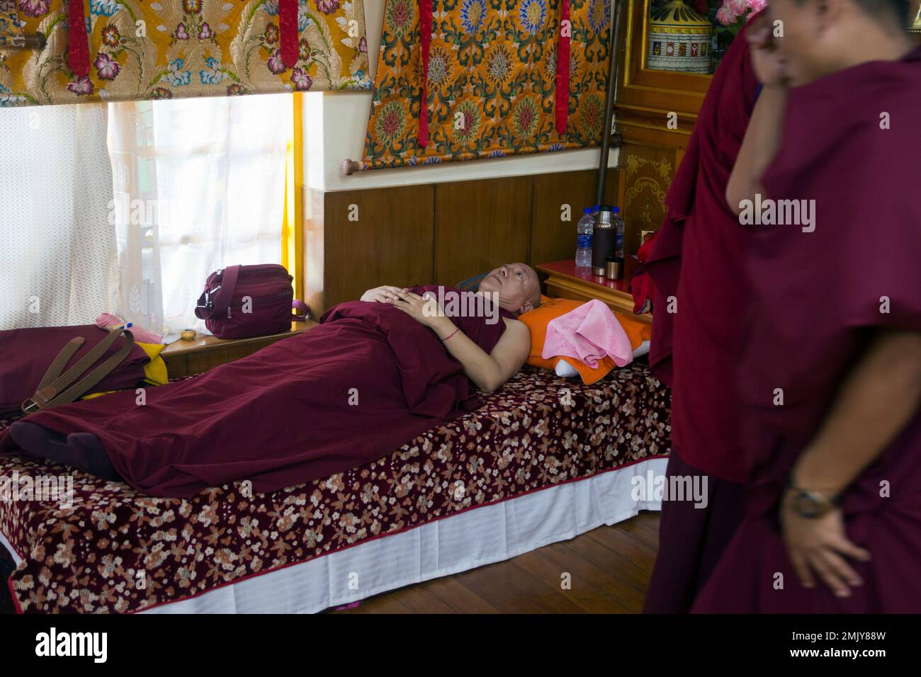 The Tibetan state oracle Nechung rests after coming out of a trance in ...