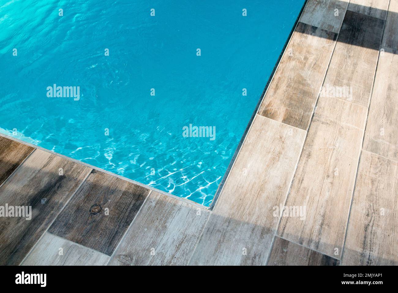 outdoors corner swimming pool detail with blue water Stock Photo - Alamy