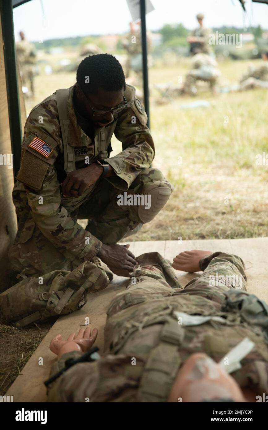 A U.S. Soldier provides first aid to a burn during the medical lane to ...