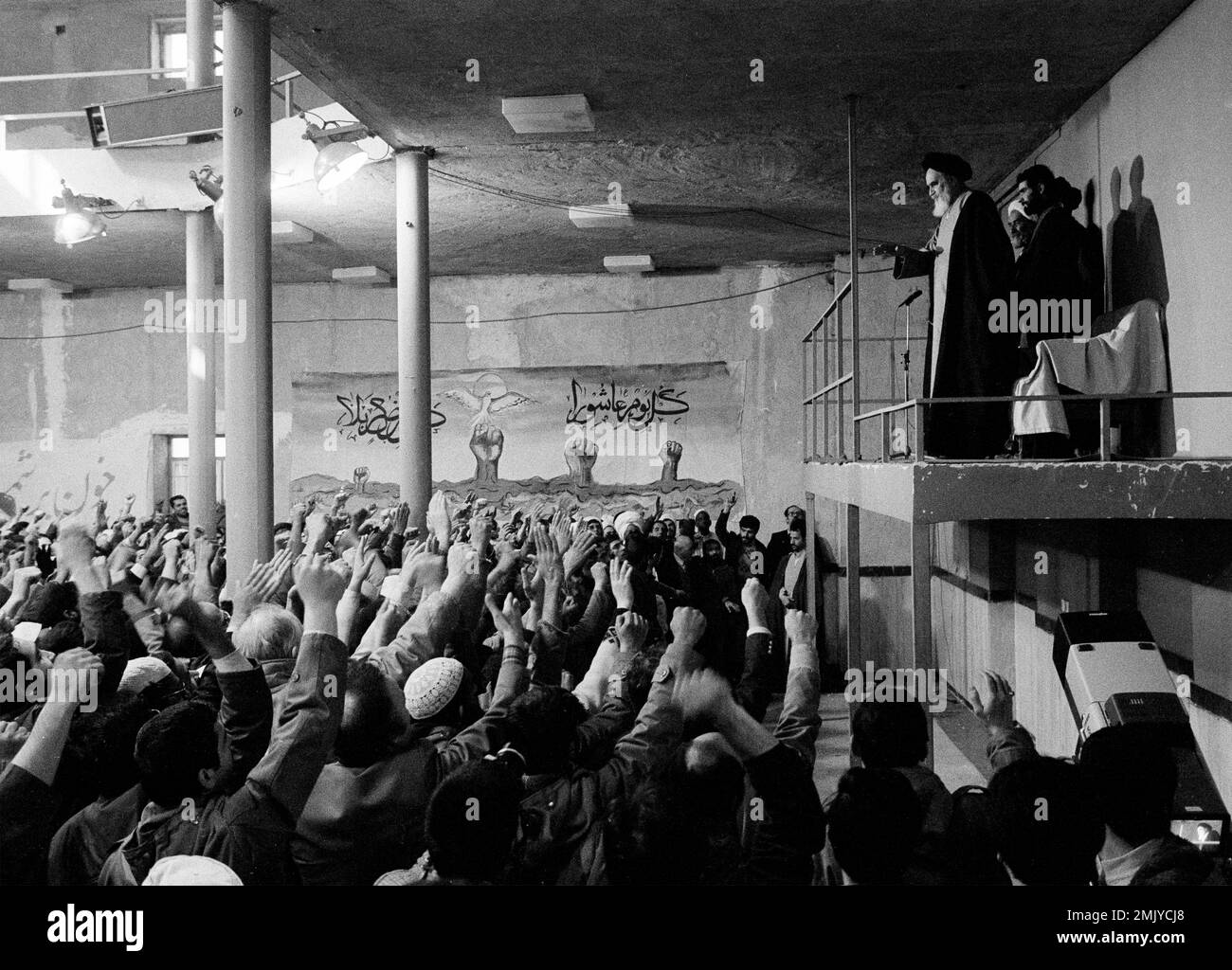 Ayatollah Khomeini waves to his followers as he arrives at the ...