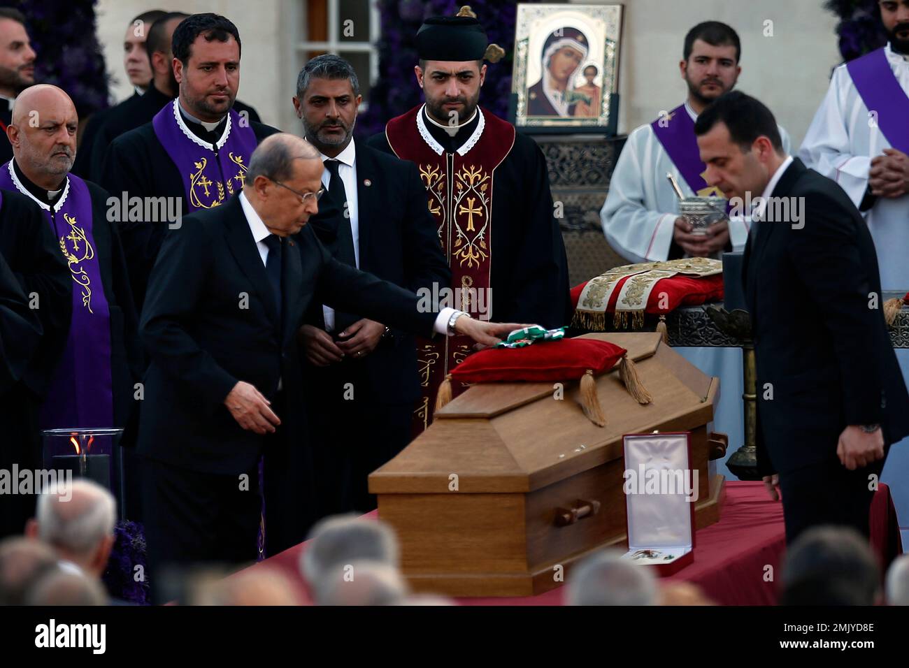 Lebanese President Michel Aoun, places medals on the coffin of former ...