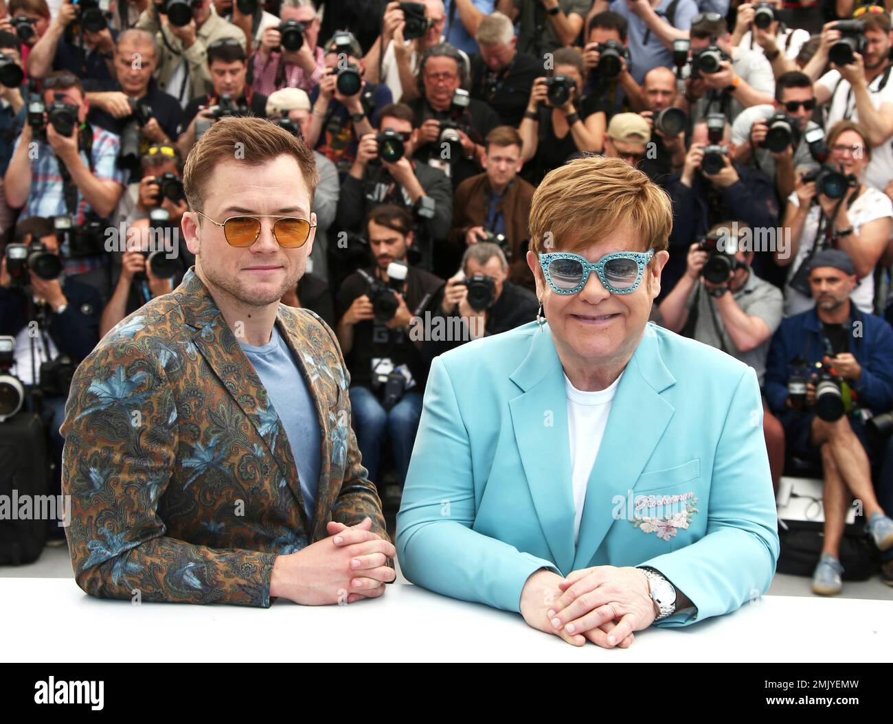Actor Taron Egerton, left, and singer Elton John pose for photographers ...