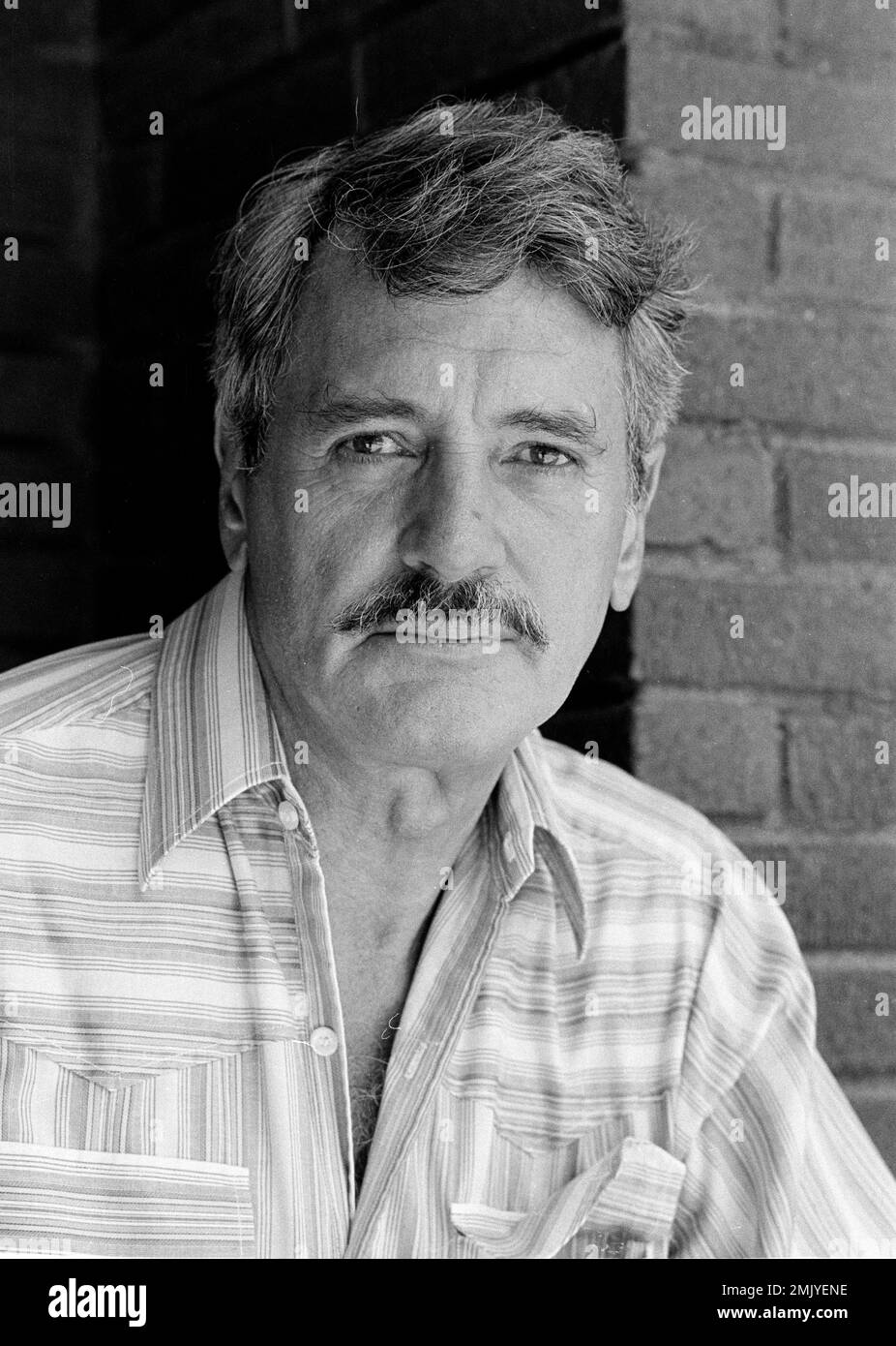 Actor Rock Hudson pauses outside a restaurant in Studio City, Calif ...