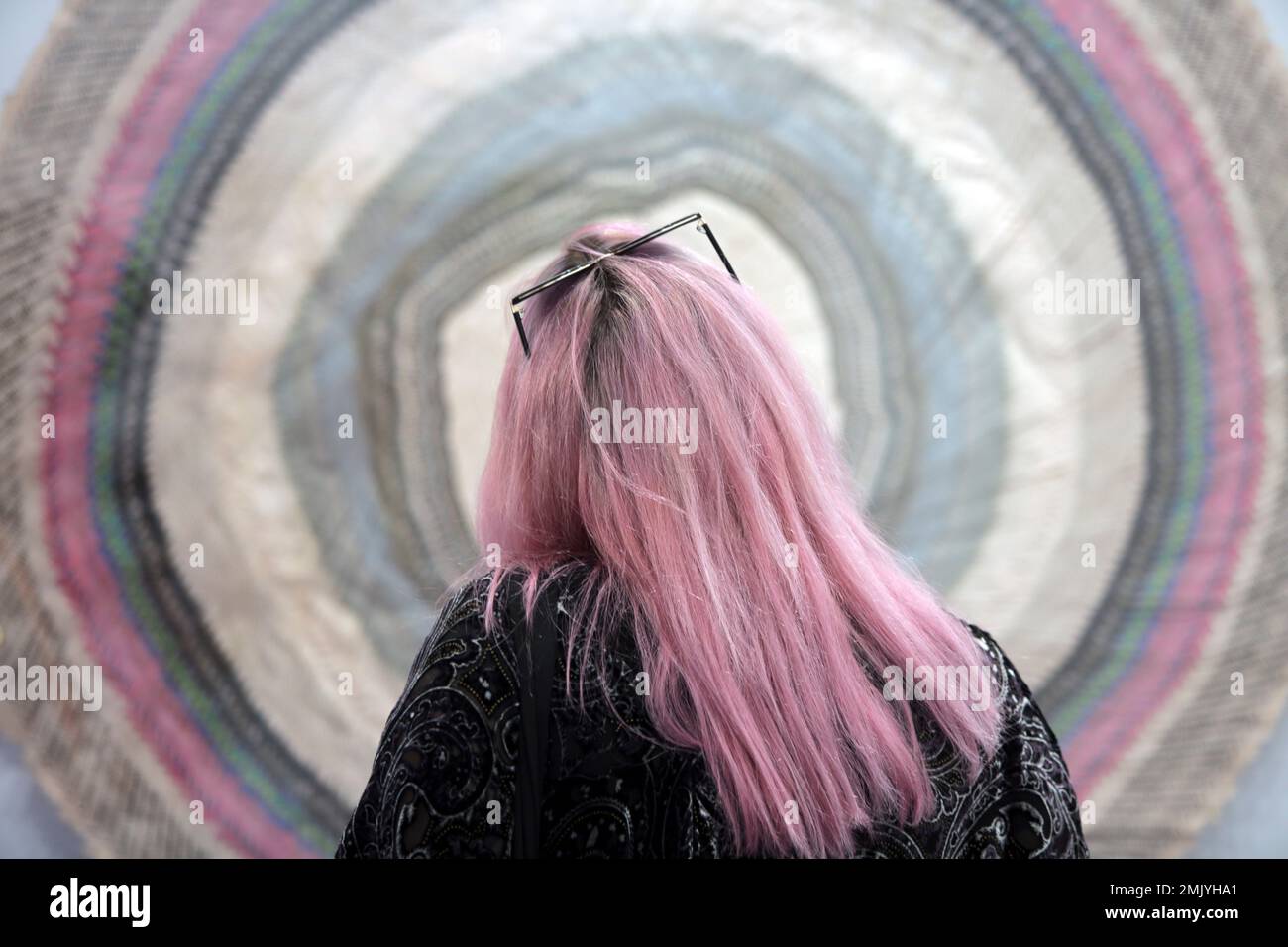 A woman looks at an art work by Colombian artist Miler Lagos during the ...