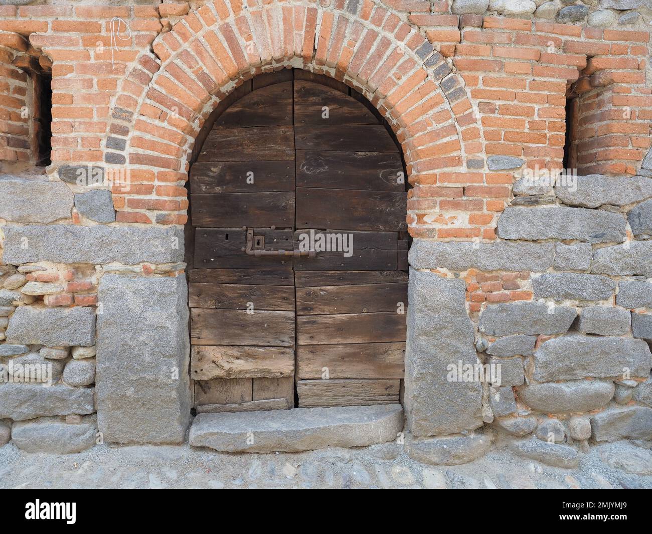 ancient medieval wooden door gate in stone and brick wall Stock Photo ...