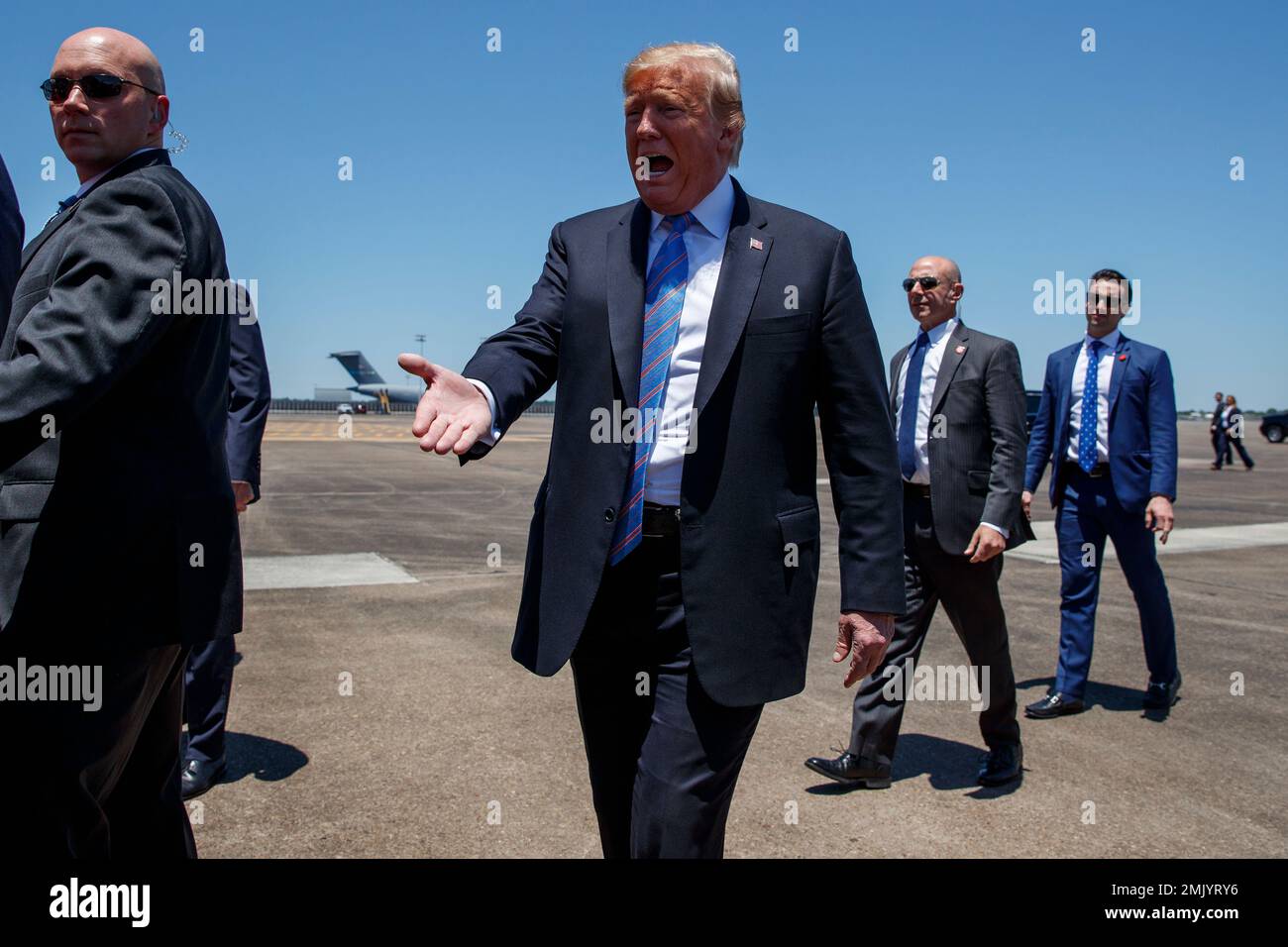 President Donald Trump reaches out to greet supporters after arriving ...