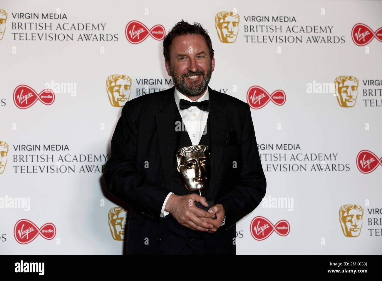 Comedian Lee Mack poses with his award for 'best entertainment ...