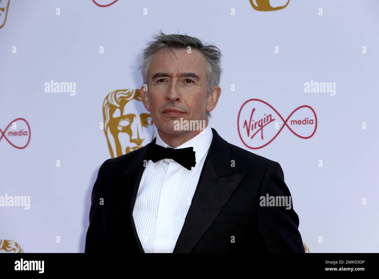 Actor Steve Coogan poses for photographers on arrival at the 2019 BAFTA ...