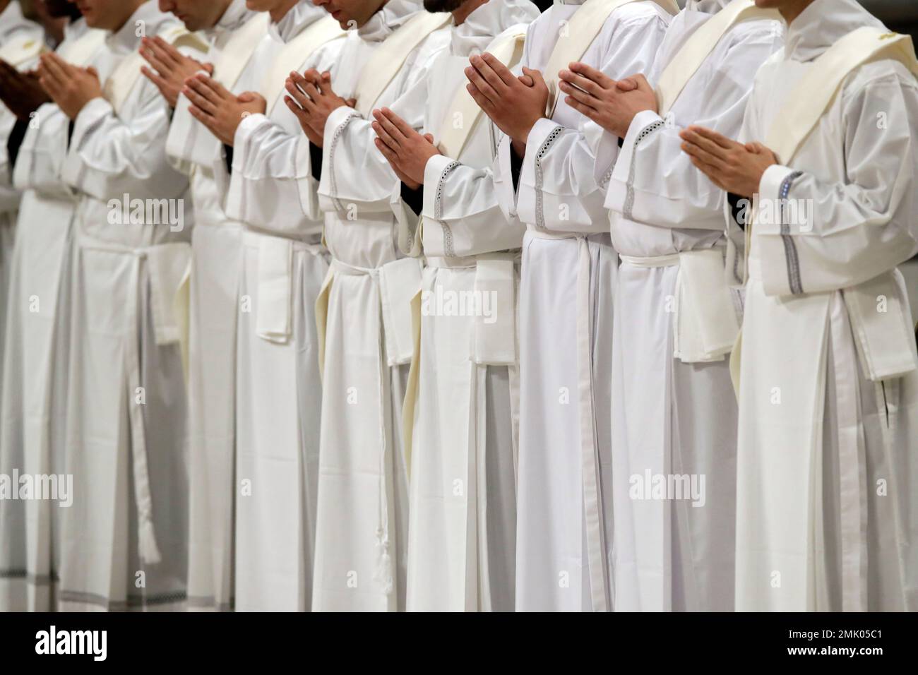Newly ordained priests pray during a ceremony led by Pope Francis in St ...