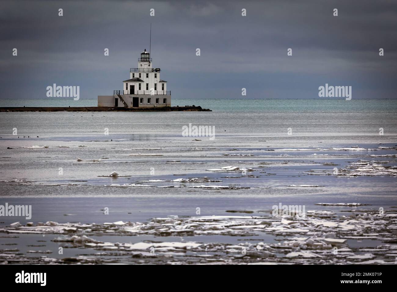 A cold January morning at the lighthouse, with ice in the harbor, at ...