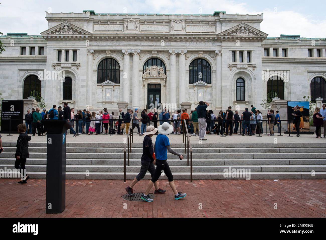 Customers wait in line for the grand opening of Apple's new store ...