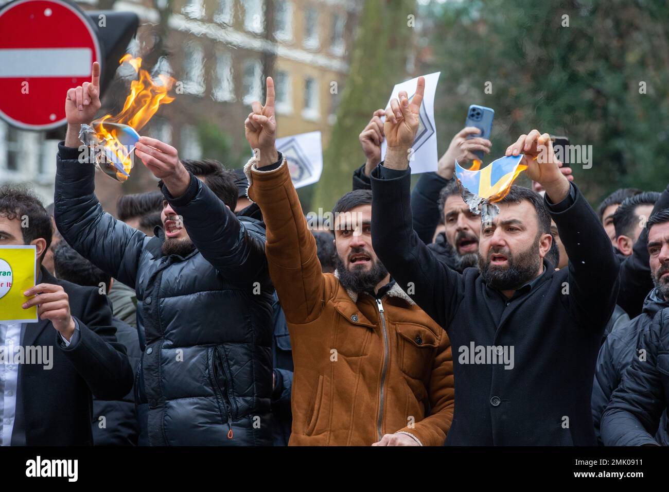 London, England, UK. 28th Jan, 2023. Muslim protesters burn Swedish and ...