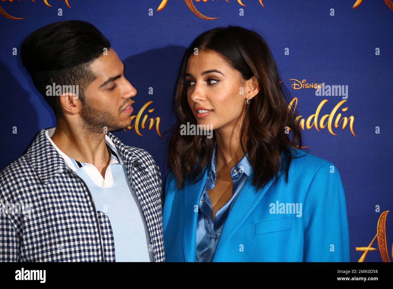 Actors Mena Massoud, left, and Naomi Scott pose for photographers at ...