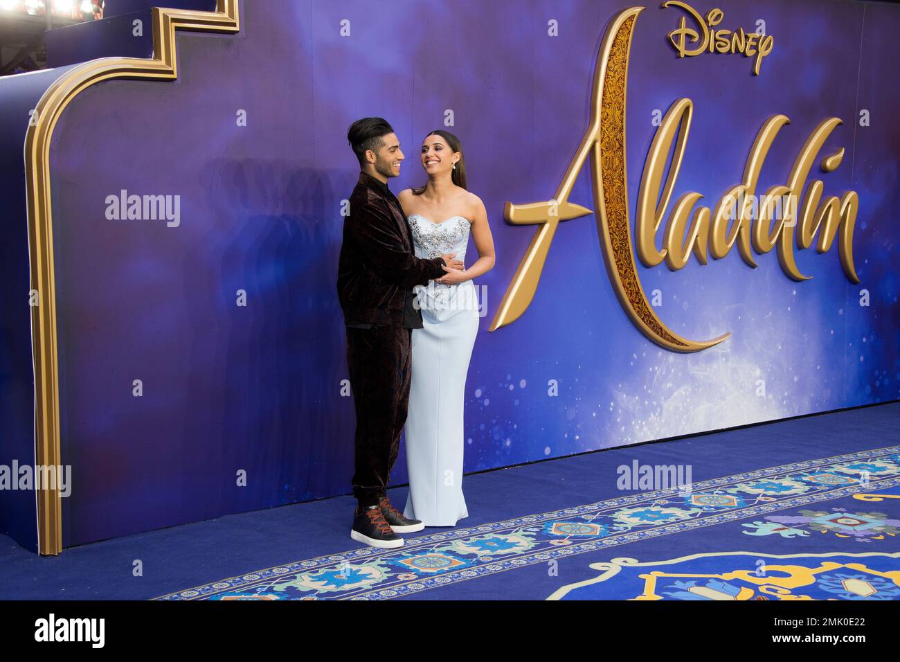 Actors Naomi Scott, right and Mena Massoud pose for photographers upon ...
