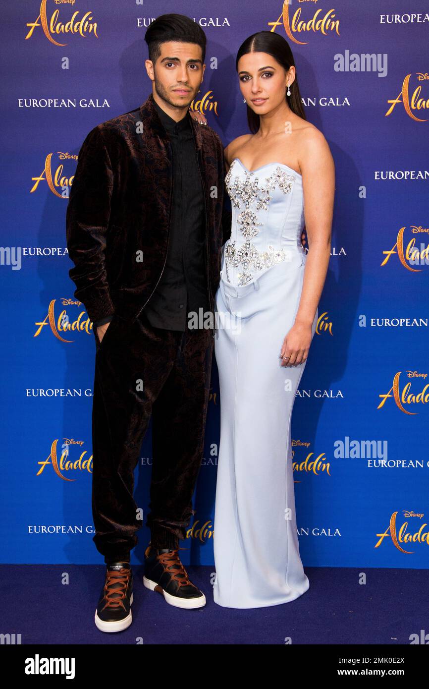 Actors Naomi Scott, right and Mena Massoud pose for photographers upon ...