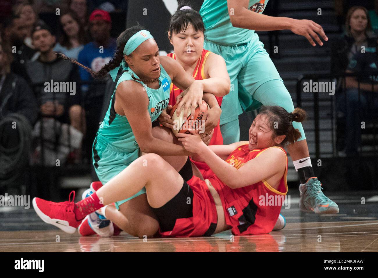 China center Li Yueru, center, and forward Zhang Ru, bottom, fight for ...