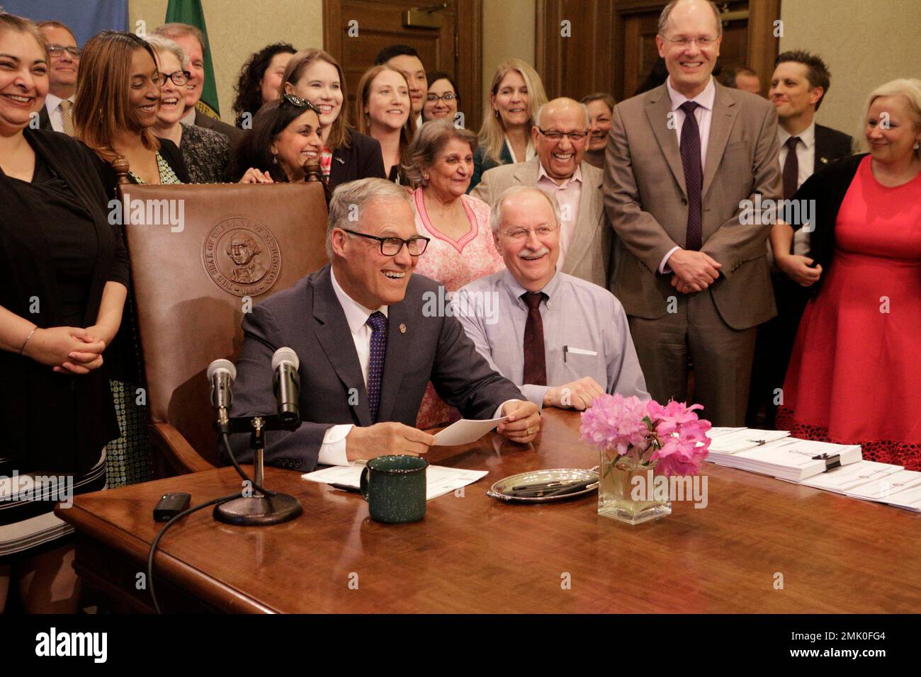 Washington Gov. Jay Inslee, left seated, laughs with former House ...