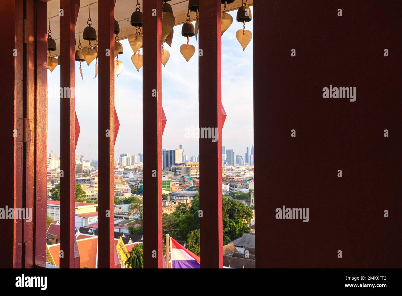 View of Bangkok, Thailand through window of Buddhist temple with bells ...