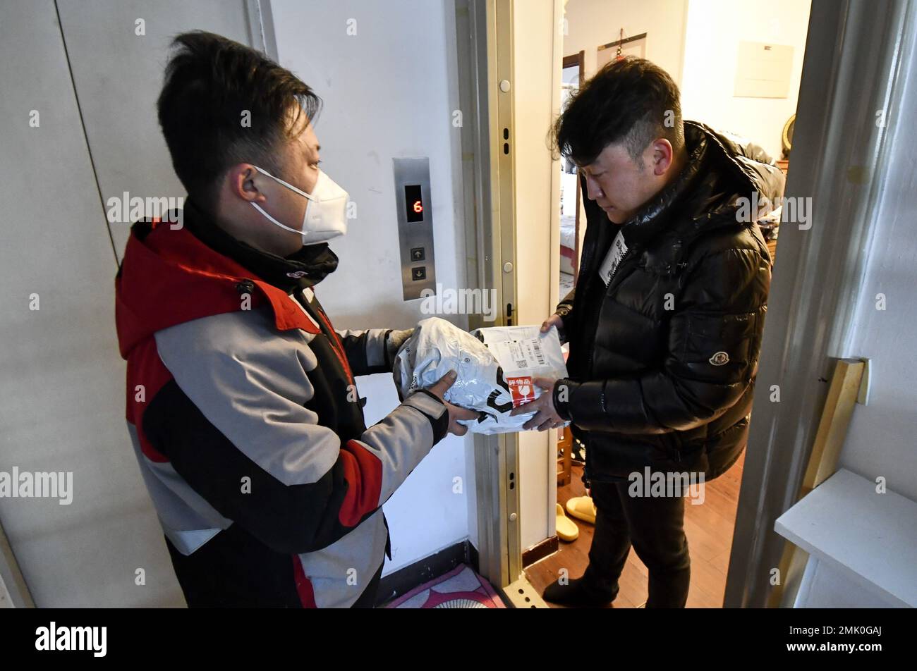 Beijing, China. 28th Jan, 2023. Delivery man Jiang Shuangjian delivers ...