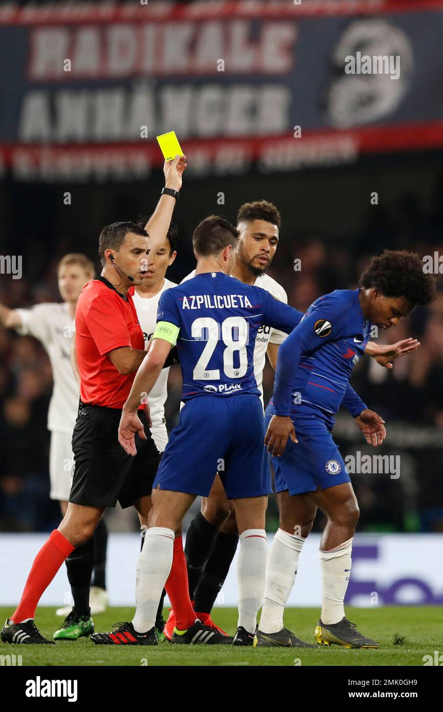 Referee Ovidiu Alin Hategan of Romania shows a yellow card to Frankfurt ...