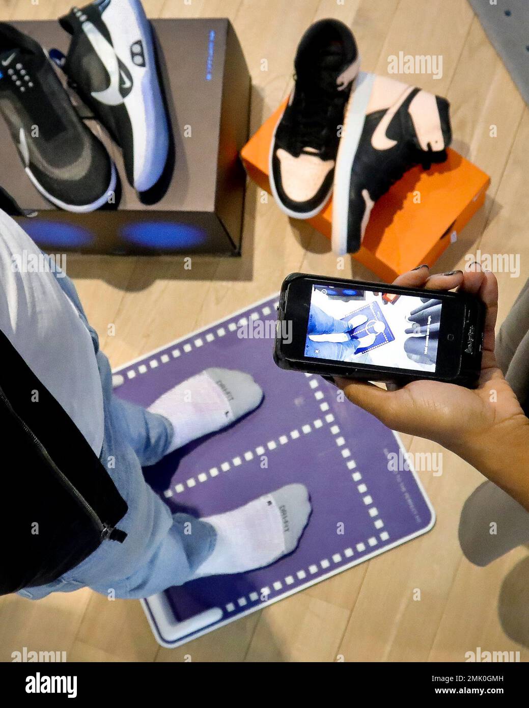 Nike officials demonstrate the company's foot-scanning tool on its app ...