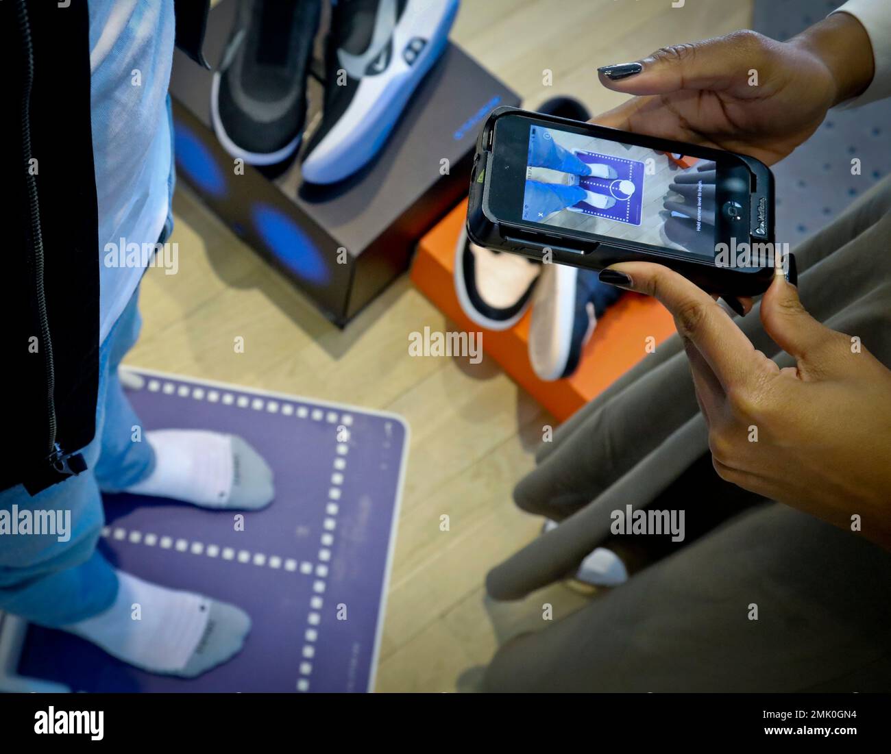 Nike officials demonstrate the company's foot-scanning tool on its app ...