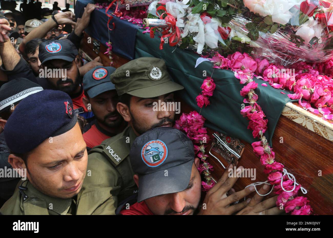 Pakistani police officers carry the coffin of their colleague at his ...