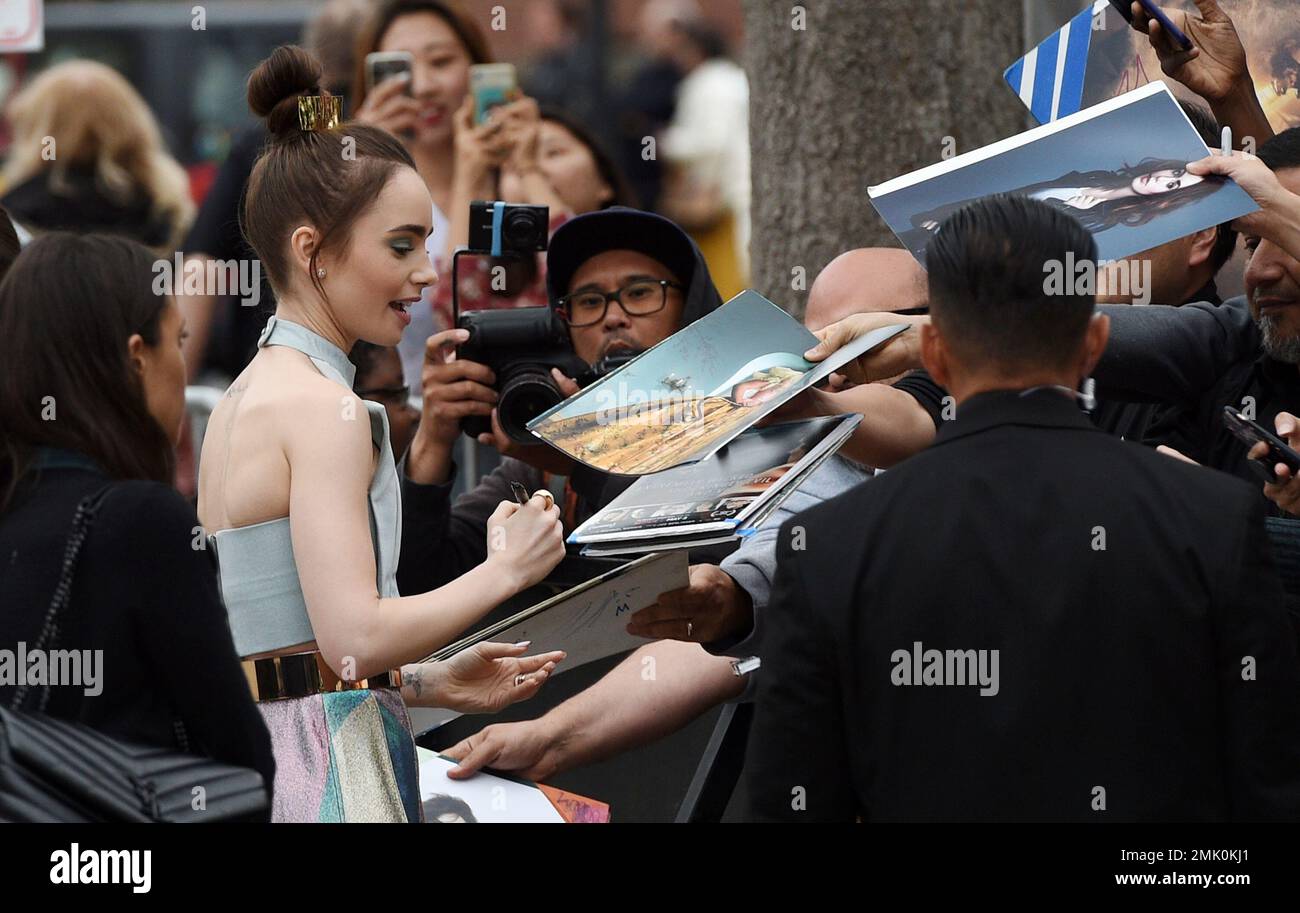 Lily Collins, a cast member in "Tolkien," signs autographs at the ...