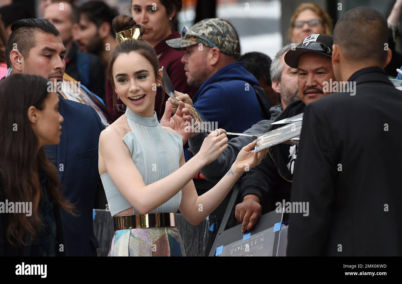 Lily Collins, a cast member in "Tolkien," signs autographs at the ...