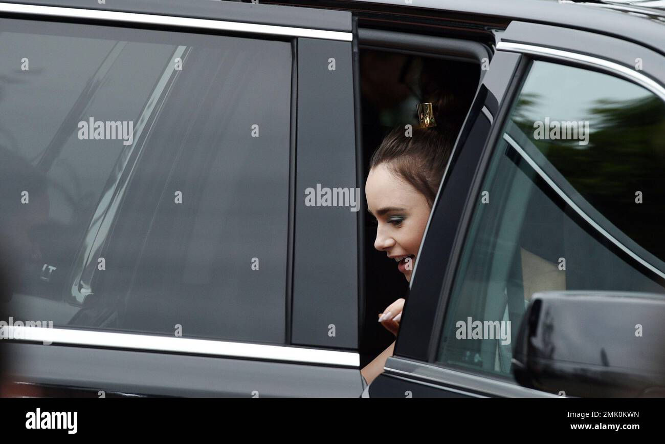 Lily Collins, a cast member in "Tolkien," exits a car as she arrives at ...