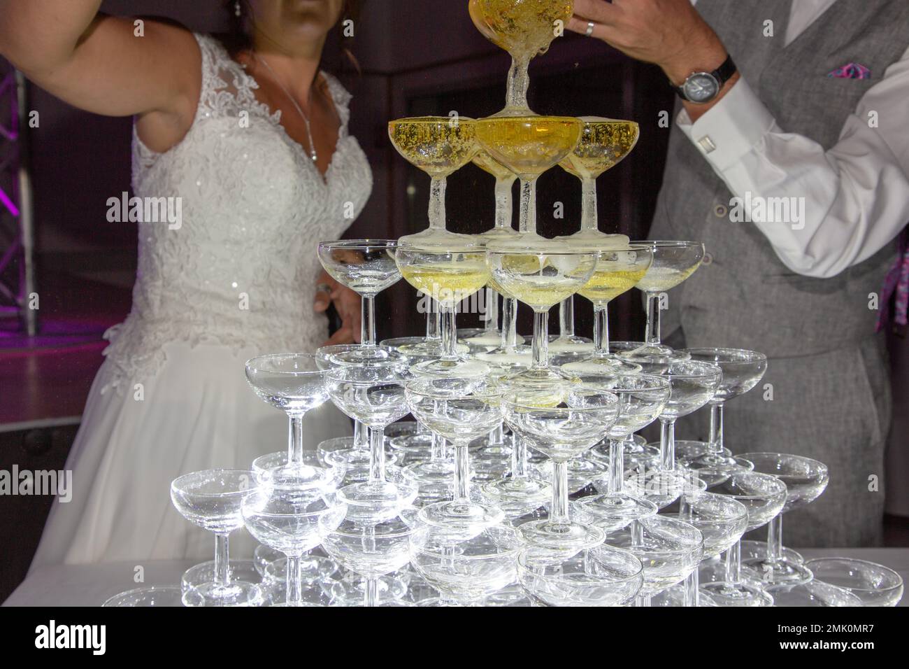 Bride wedding sight of pouring the pyramid of champagne glasses at ...