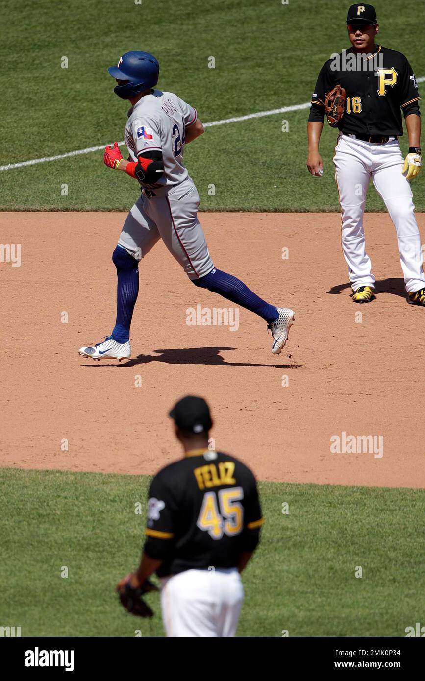 Texas Rangers' Hunter Pence, top left, rounds third past Pittsburgh ...