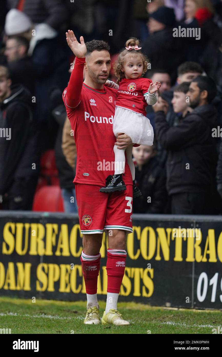 Walsall's Robbie Willmott holding a young child waves to fans after the ...