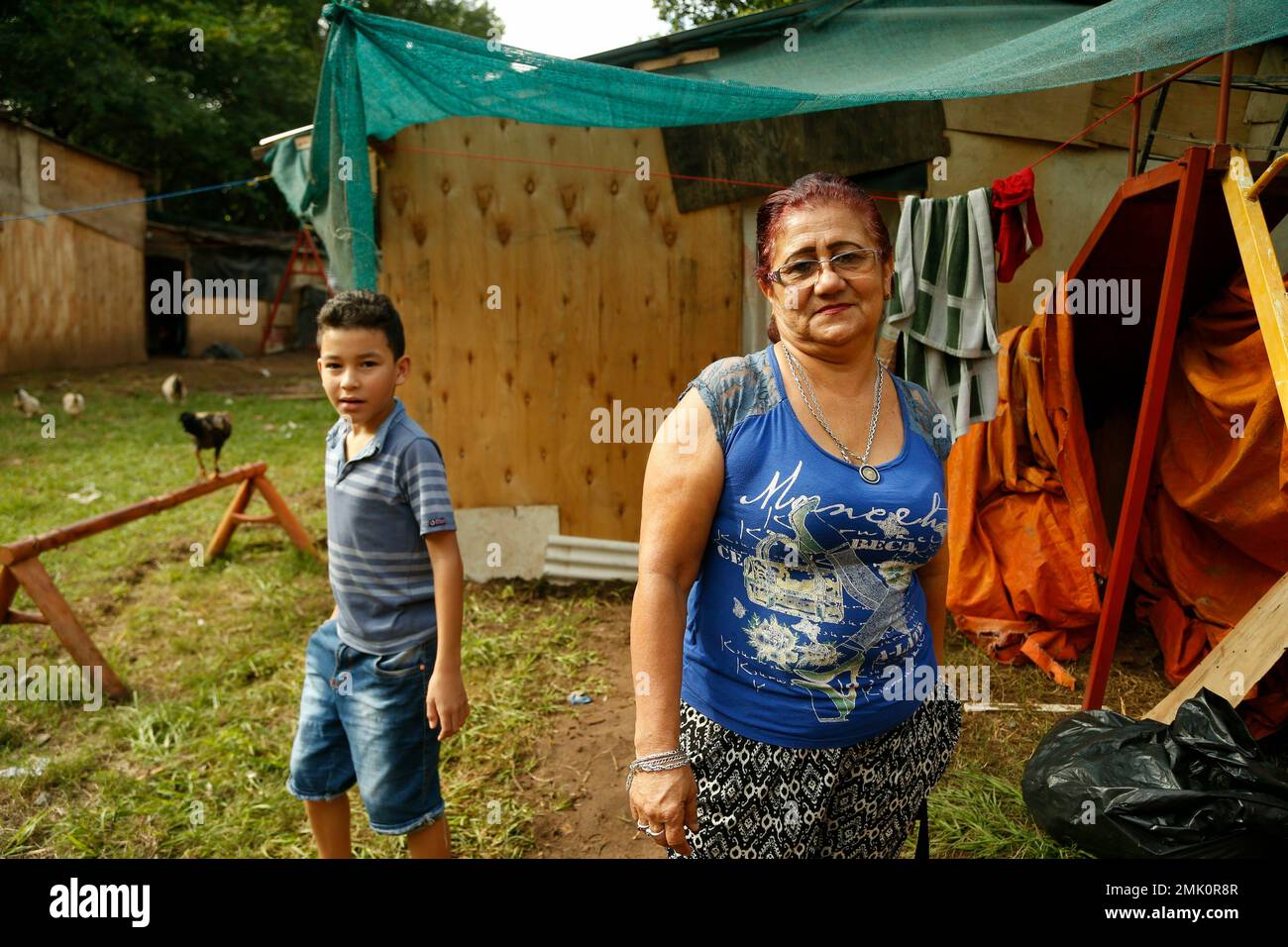 Maria Rodas and his son Kevin Daniel, displaced by floods, waits for ...