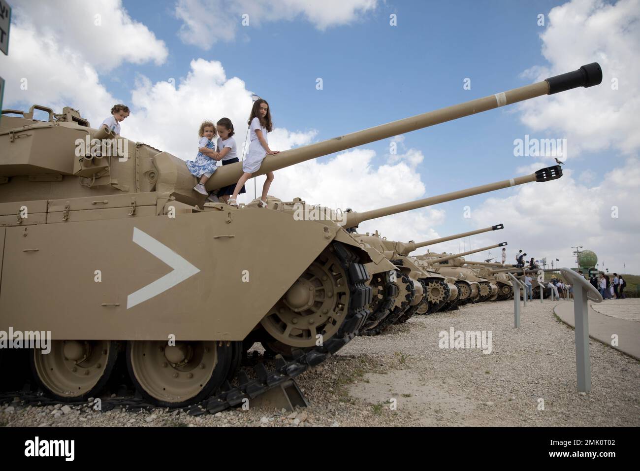 Kids sit on a tank during a ceremony marking the annual Memorial Day to ...