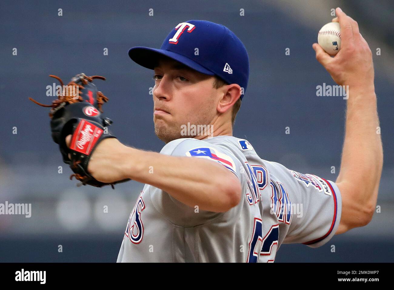 Texas Rangers starting pitcher Adrian Sampson delivers during the first ...