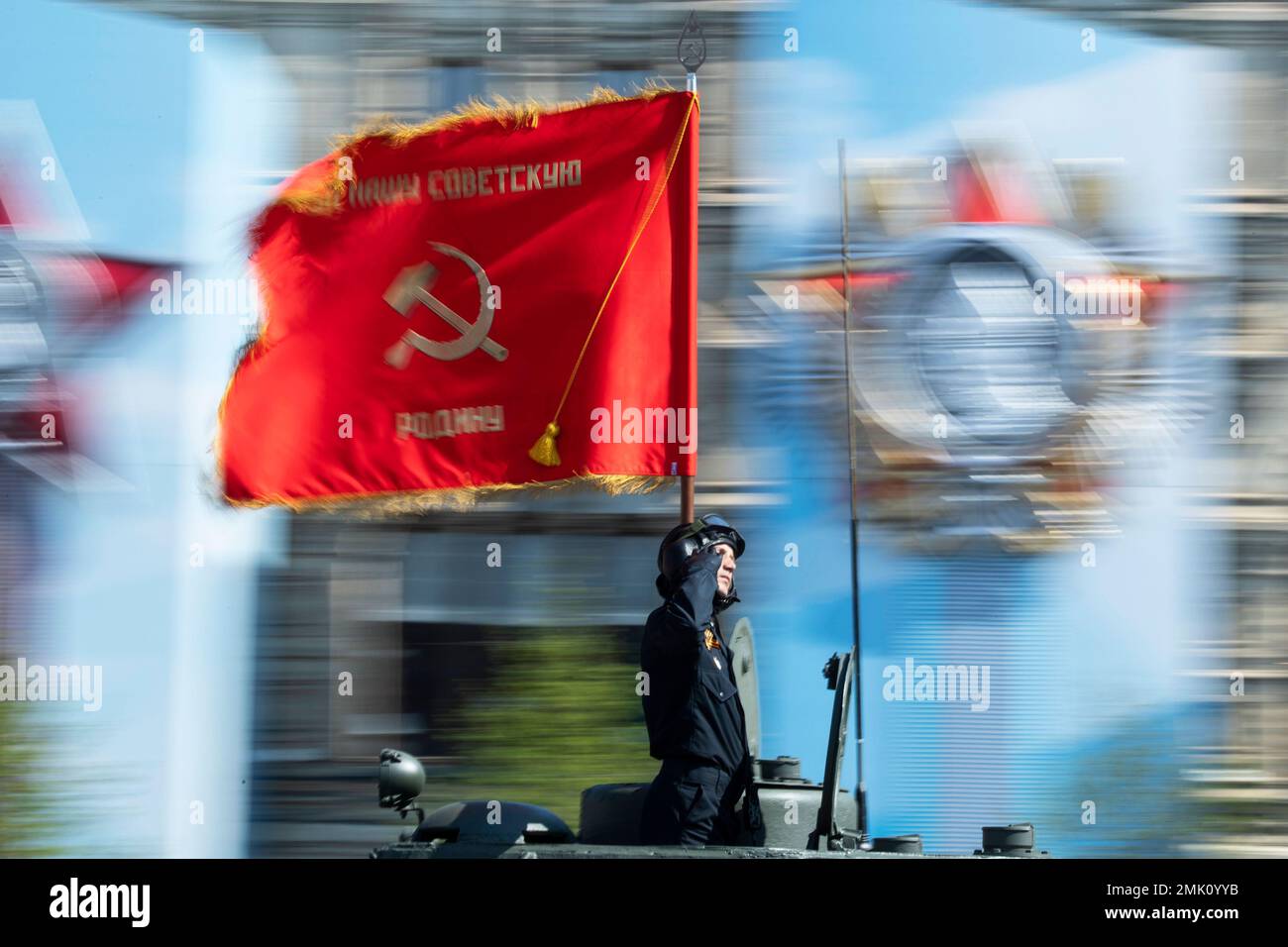 A Russian solder with a historical flag travels on the World War II era ...