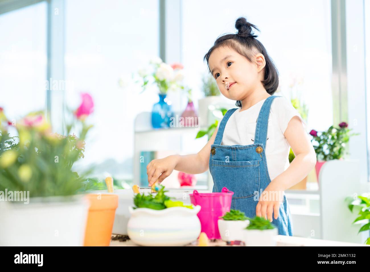 Happy little girl grow pot at home Stock Photo - Alamy