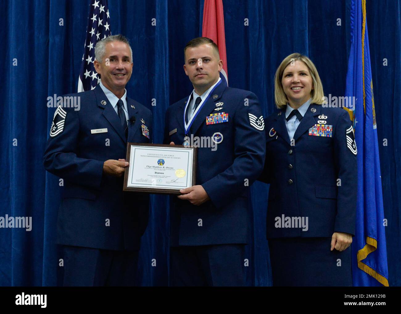 U.S. Air Force Tech Sgt. Matthew Owens receives the Distinguished Graduate Award during the ...