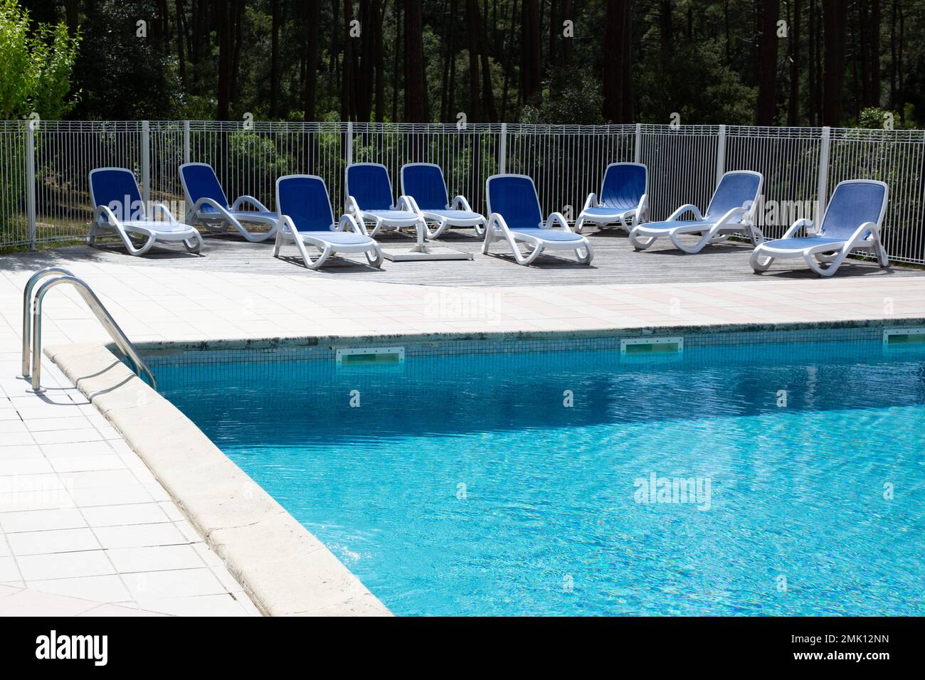 Resort Swimming Pool and bathe chair blue water in summer Stock Photo ...