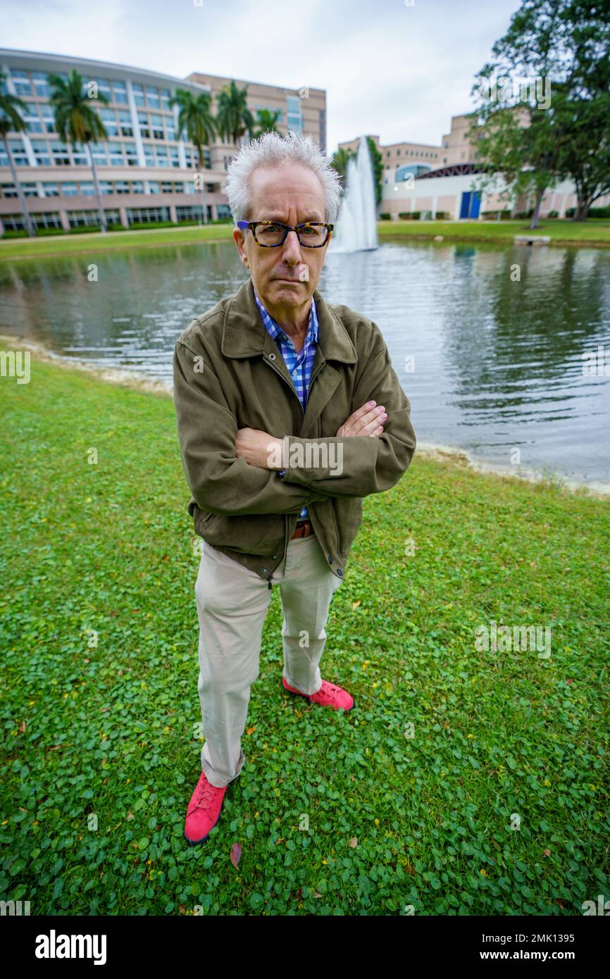 University professor on campus by a lake Stock Photo - Alamy