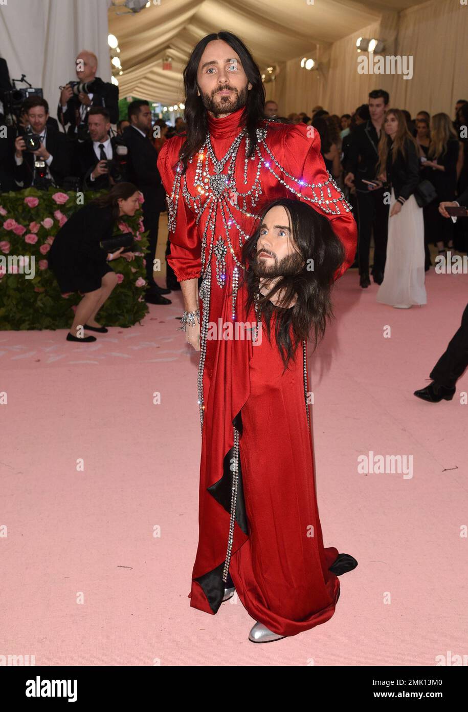 Jared Leto, holding a model of his own head, as he attends The ...